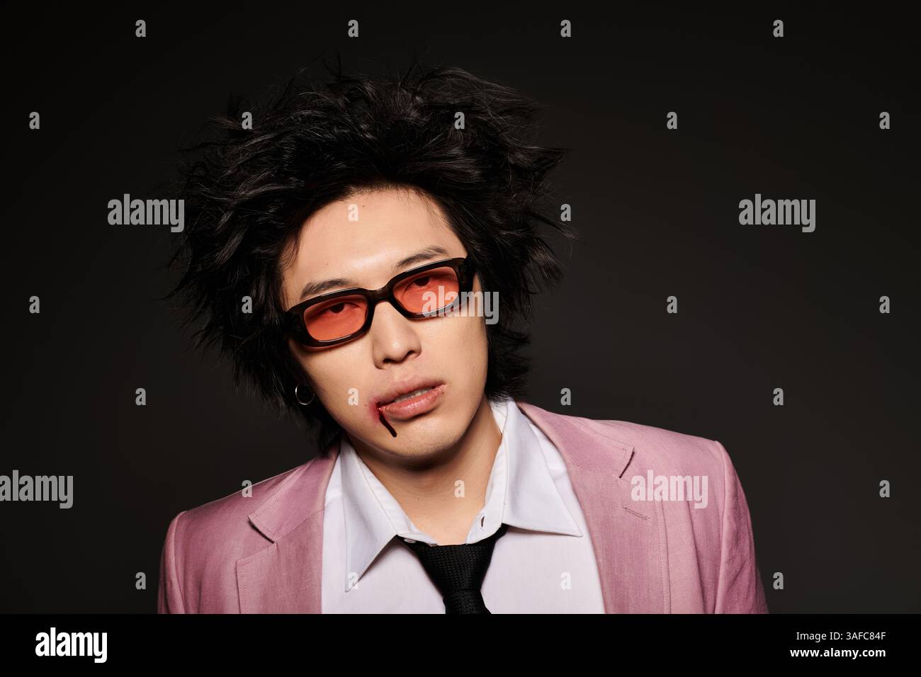 A fashionable Asian man with blood on face displays his unique style in ...