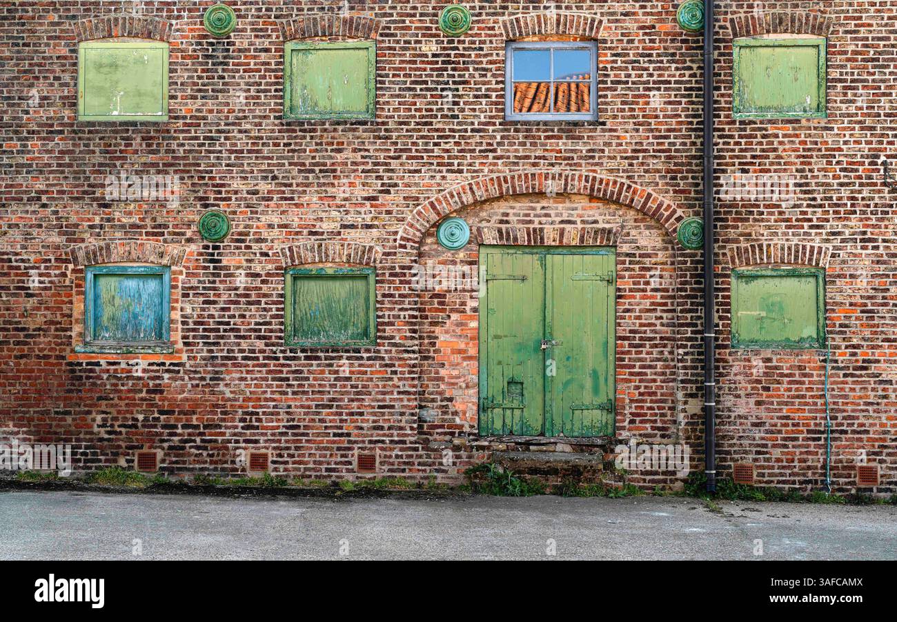 Front elevation brick wall of now disused historical warehouse with ...
