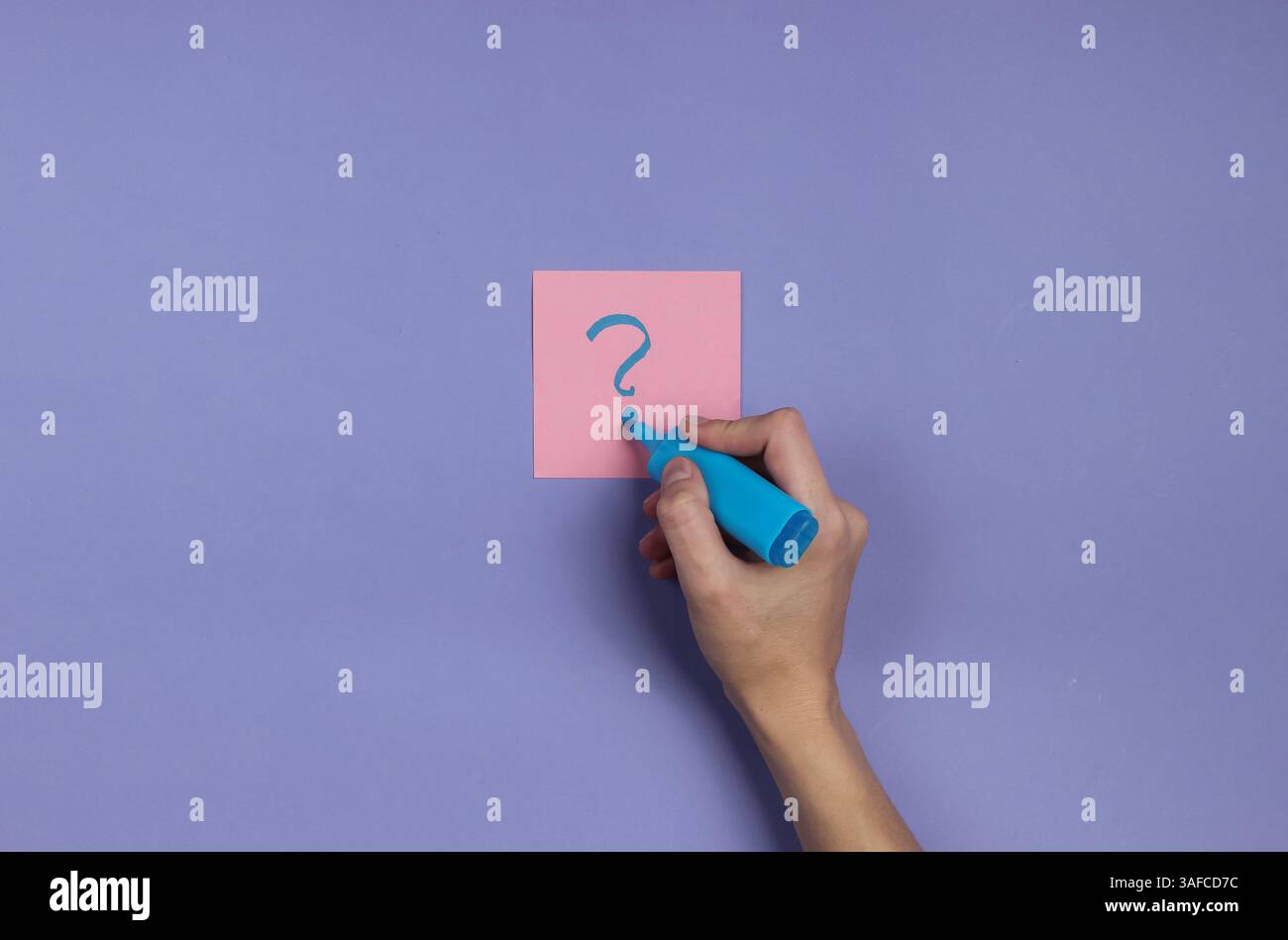 Hand holding a pencil against blue background with vignette Stock Photo ...