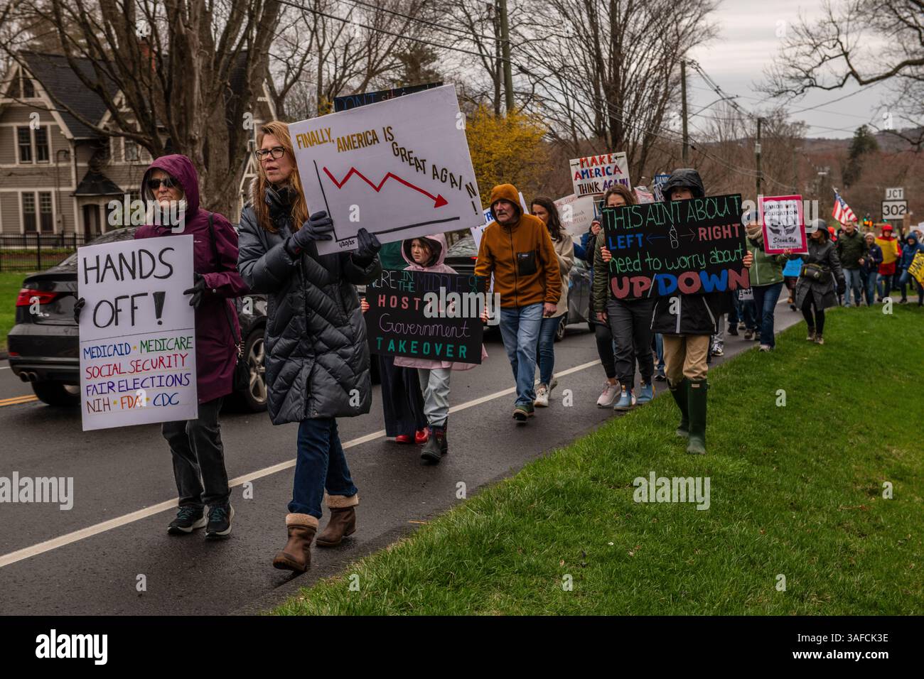 Newtown, United States. 05th Apr, 2025. Protesters march with placards ...
