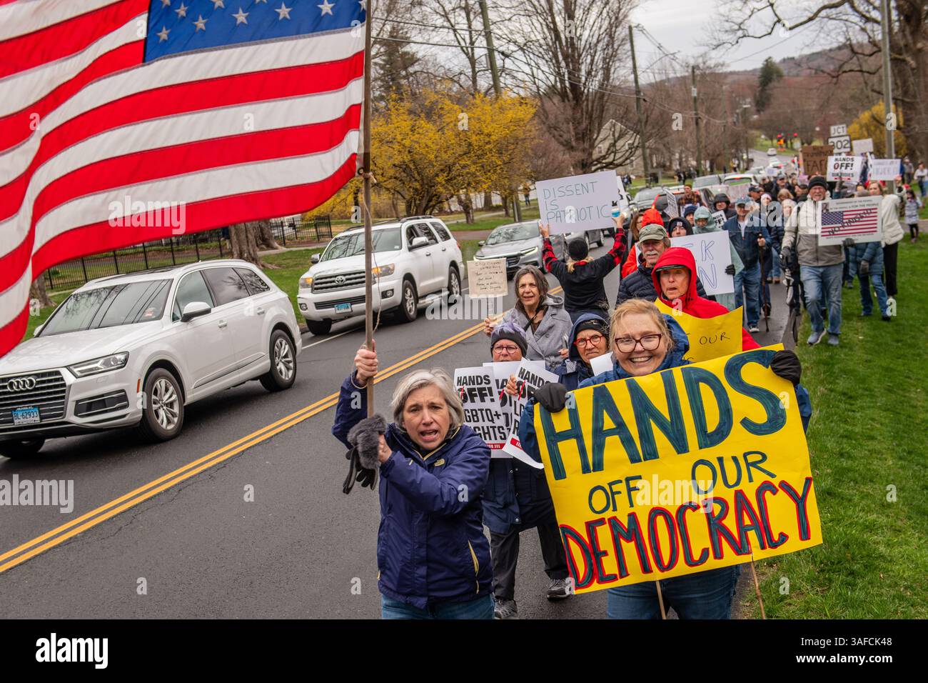 Newtown, United States. 05th Apr, 2025. Protesters march with placards ...