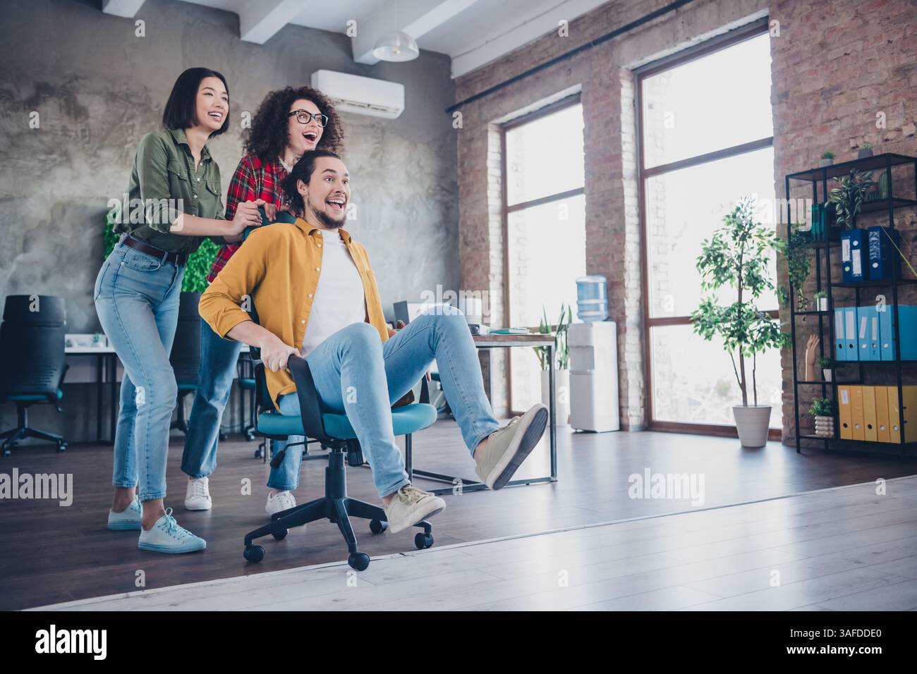 Group of Young Colleagues Enjoying a Fun Moment in a Vibrant Modern ...