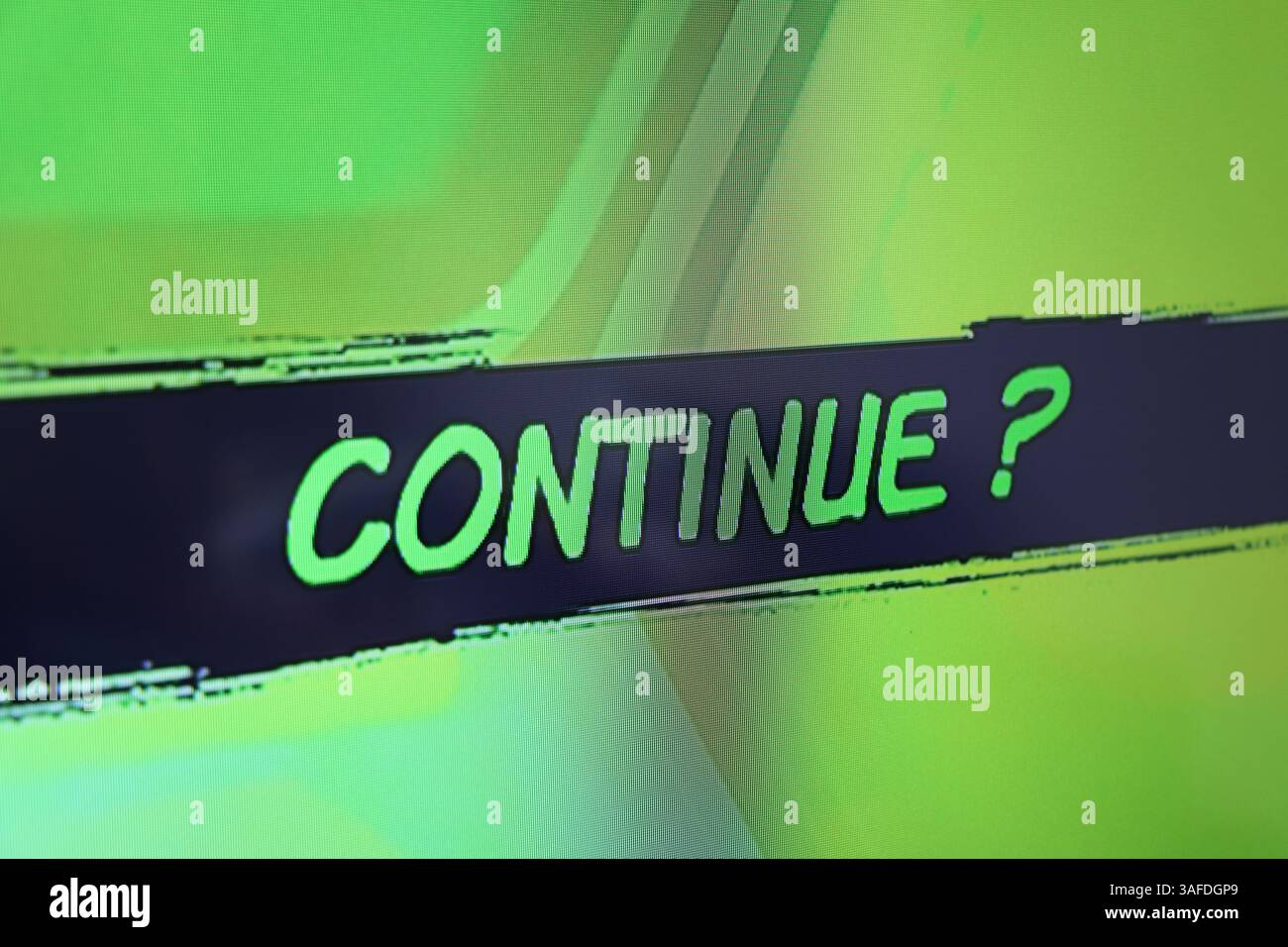 Retro video game screen with green continue prompt and abstract ...