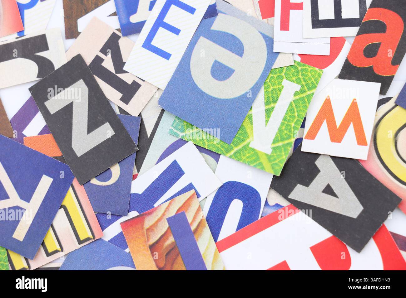 Colorful collage of various cut-out letters in a random arrangement ...