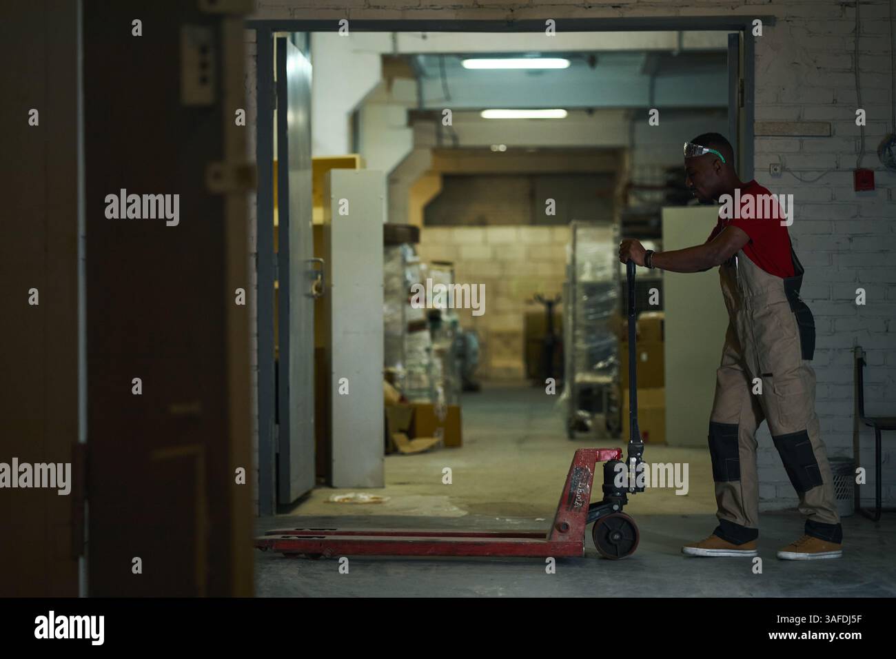 Worker Using Trolley For Load Stock Photo - Alamy