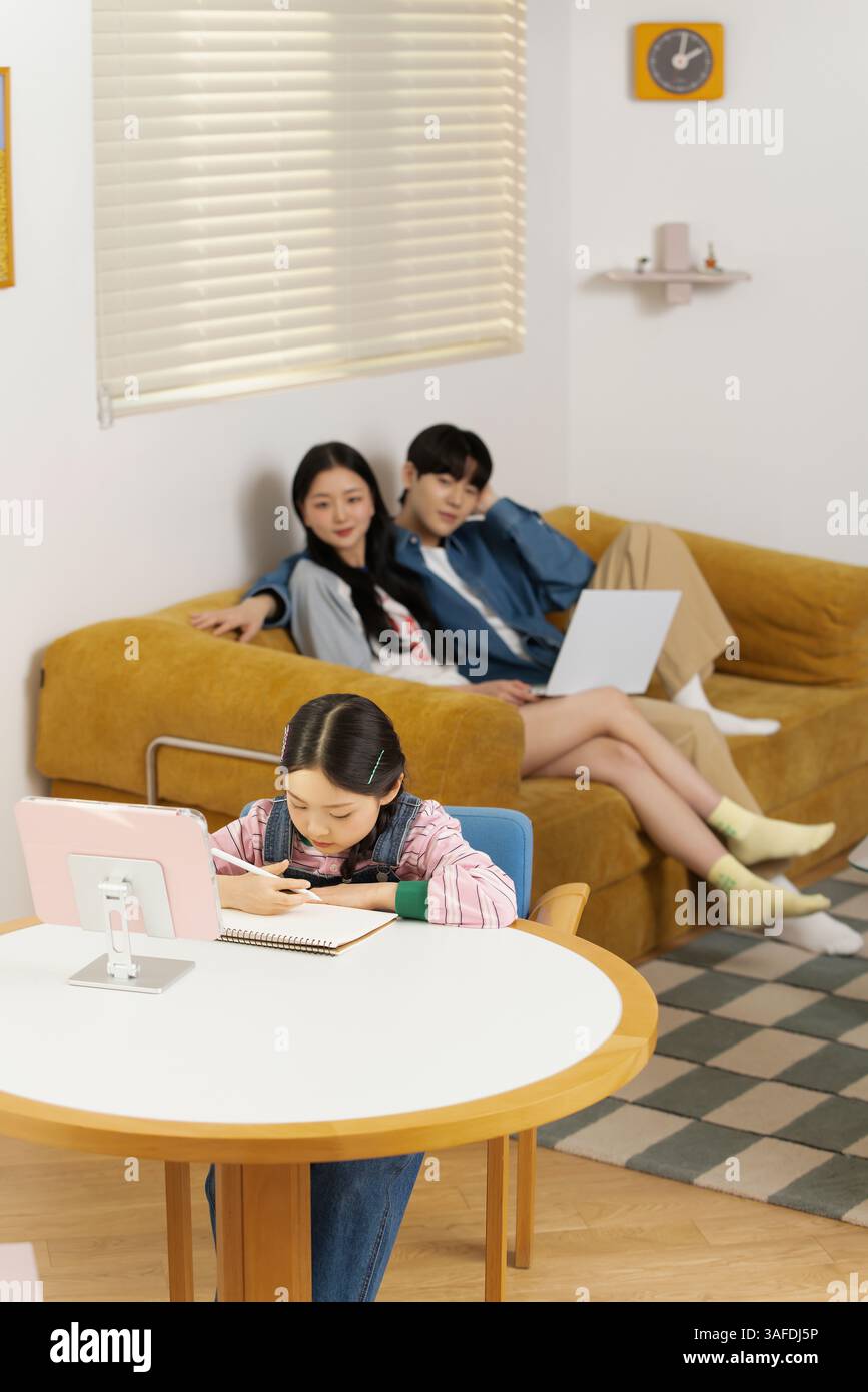 Parents watching their child learn from behind Stock Photo - Alamy