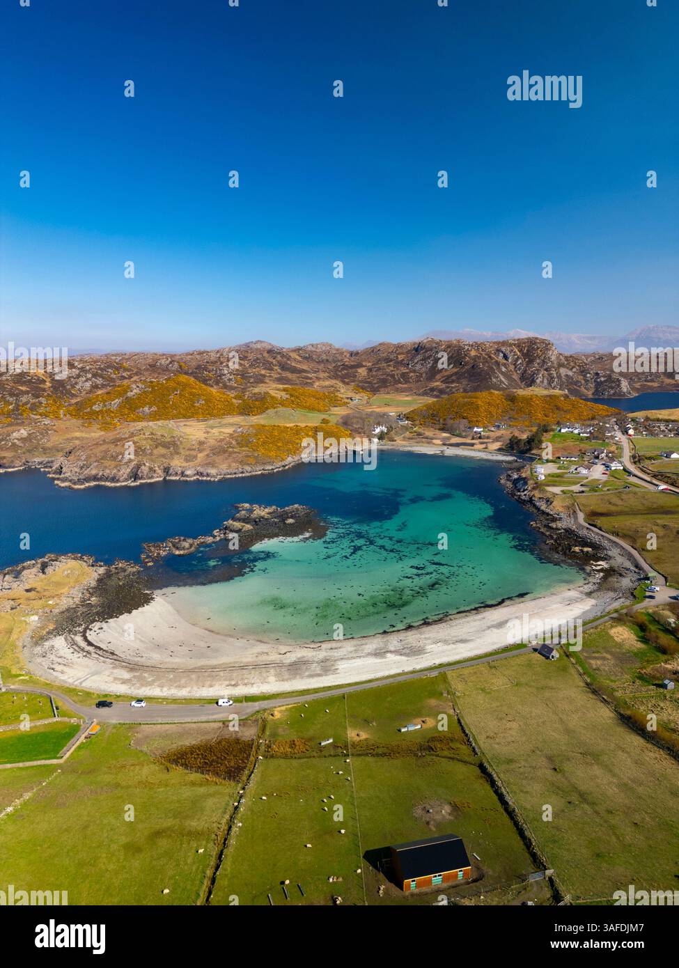 Aerial view of turquoise water and sandy beach at village of Scourie on ...