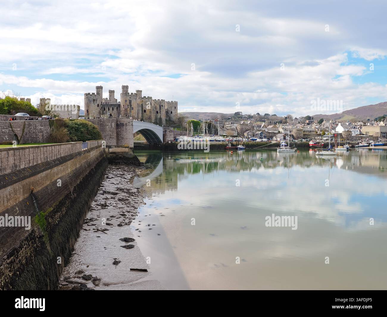 Conwy, Wales, UK, 03-22-2025: Historic stone castle by tranquil river ...