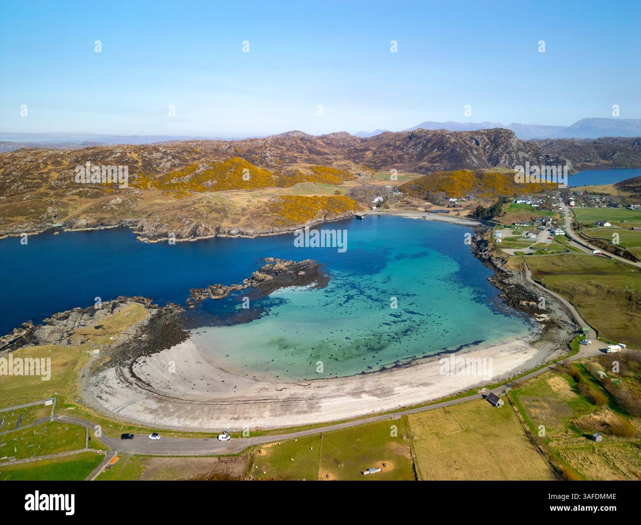Aerial view of turquoise water and sandy beach at village of Scourie on ...
