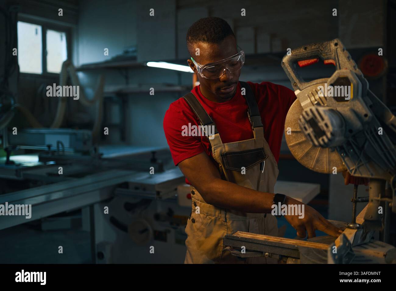 African American worker setting the lathe before work in factory Stock ...