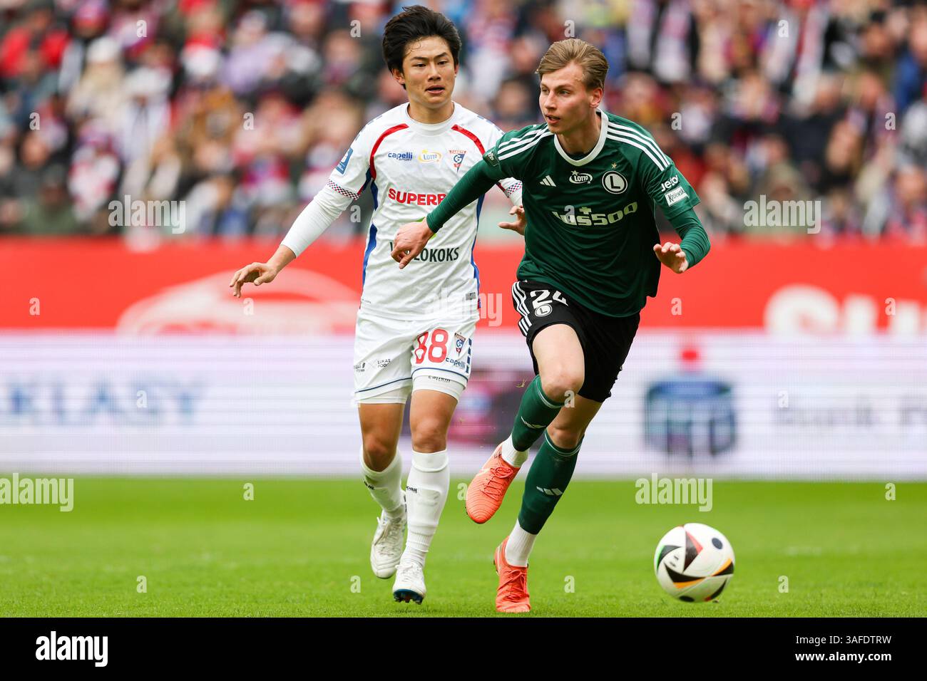 Zabrze, Poland. 06th Apr, 2025. Yosuke Furukawa of Gornik Zabrze (L) and Jan Ziolkowski of Legia ...