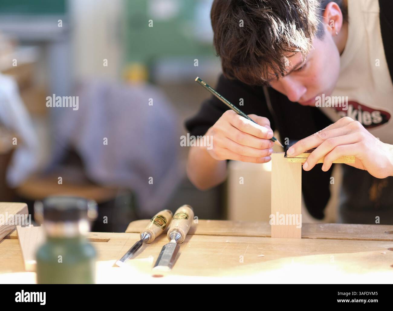 Stuttgart, Germany. 07th Apr, 2025. Trainees work on a workpiece in a ...