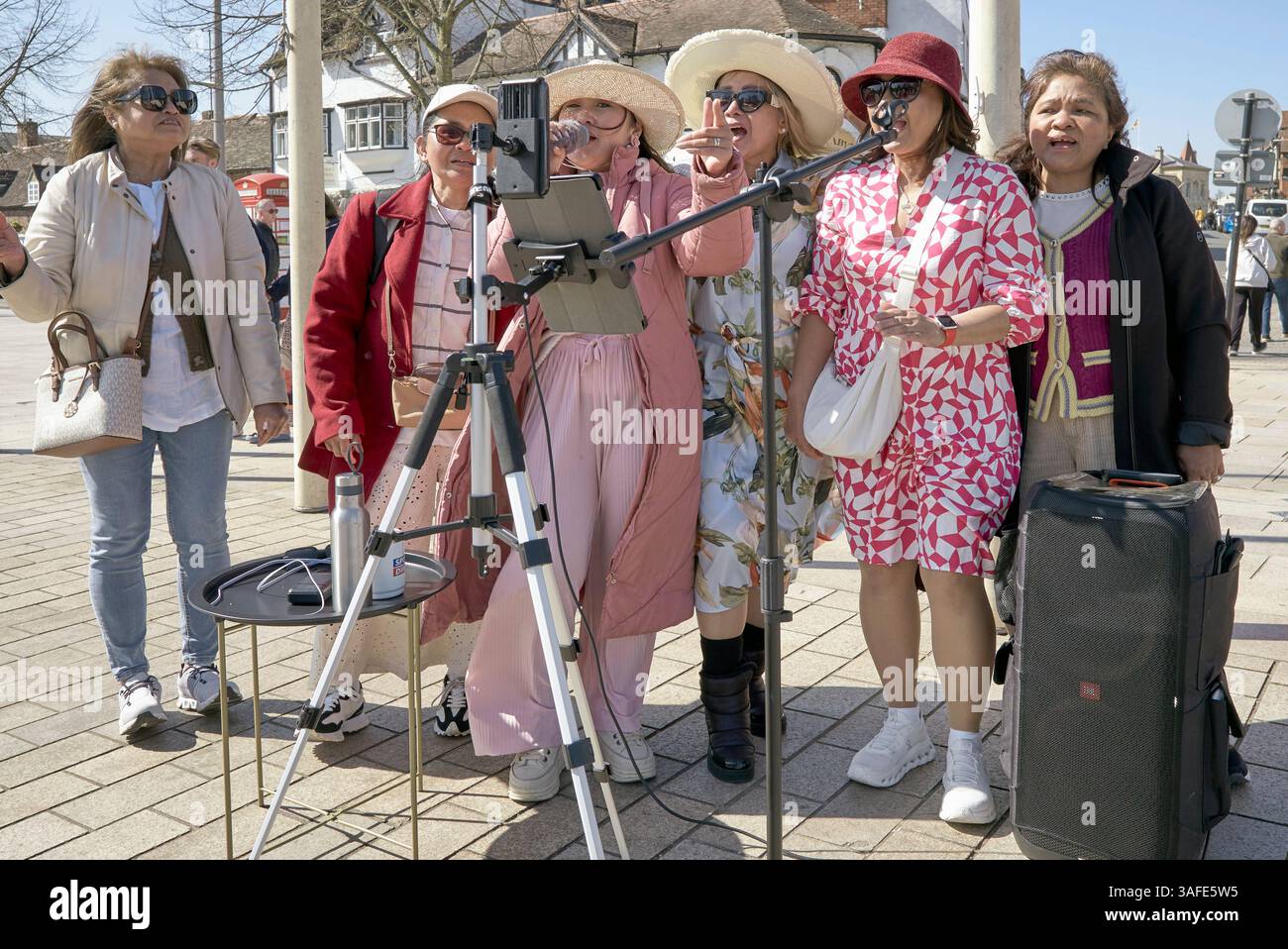 Group of visiting Filipino ladies join in with street busker and sing ...