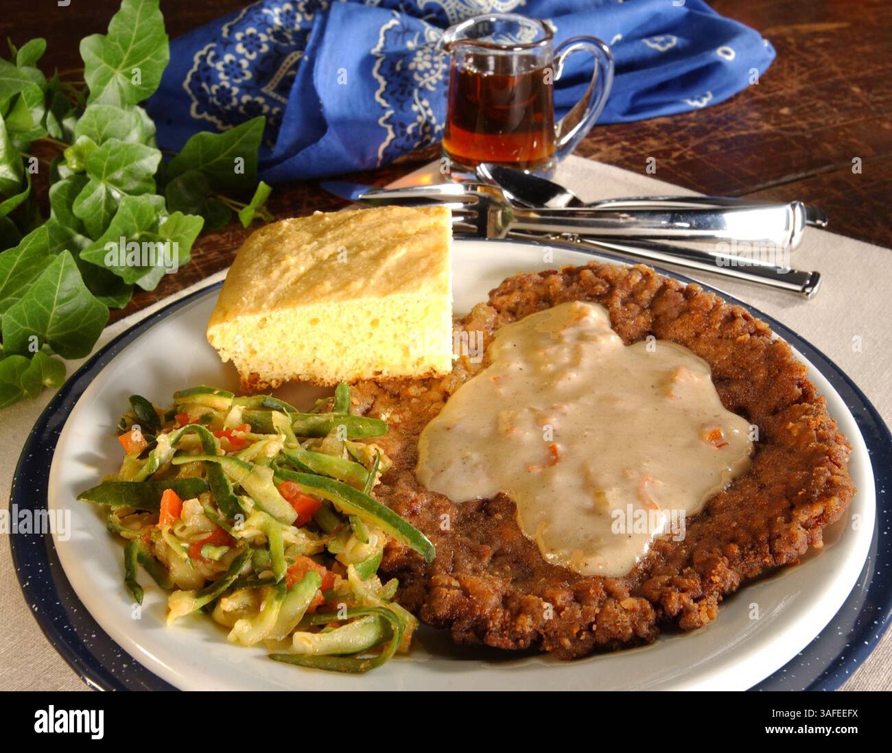 February 21, 2002 - Chicago, IL, USA - Chicken-fried steak with tomato ...