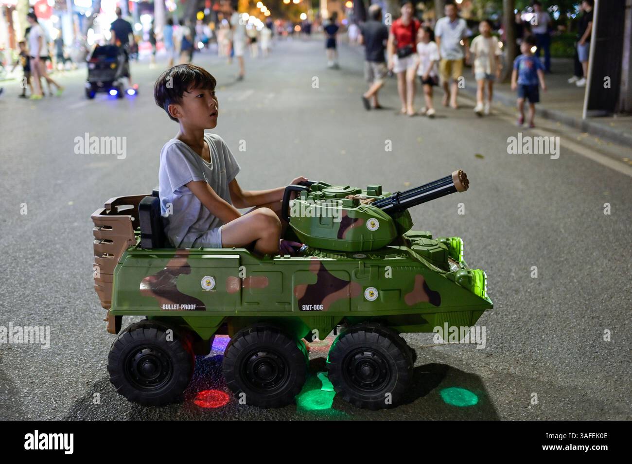 VIETNAM, Hanoi city, Vietnam war today, children drive plastic tank toy ...