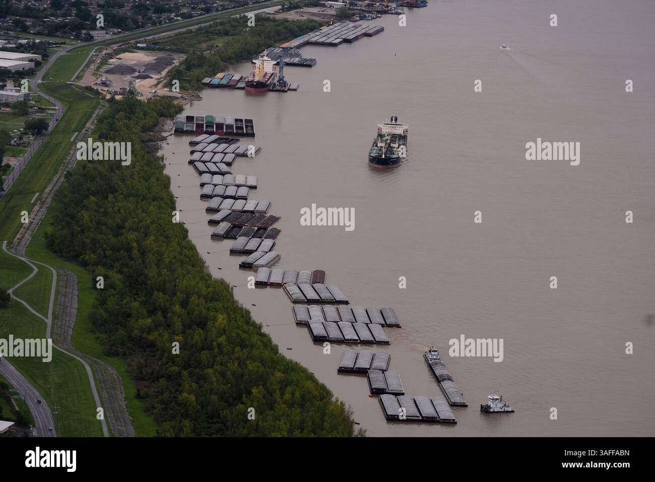 Tankers and barges line the East bank along the Mississippi River in ...