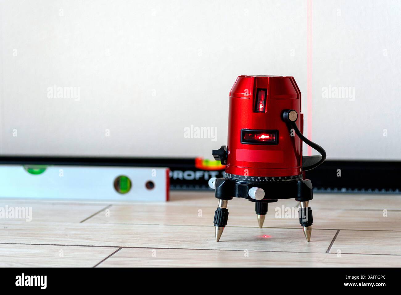 Laser level and Bubble levels, lines on the wall. measuring with red ...