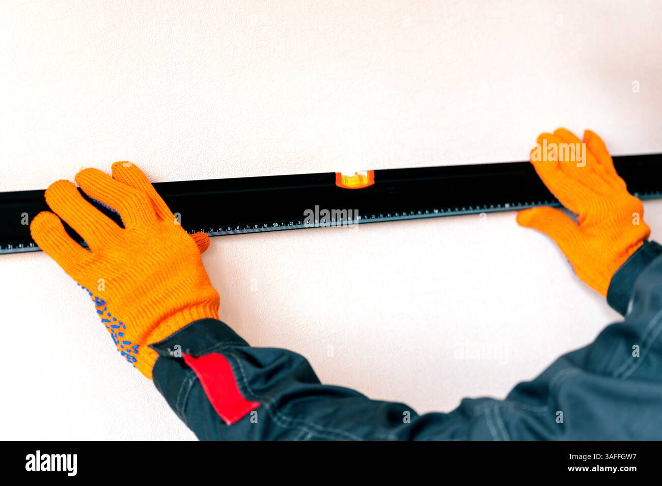 Worker's hands with bubble level. measuring with bubble level ...