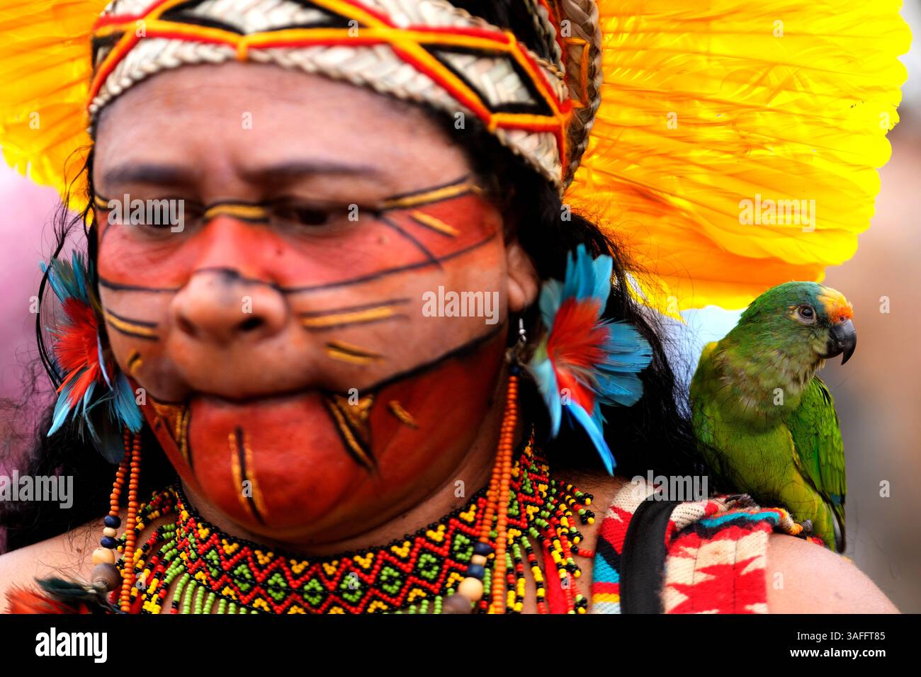 A Pataxo Indigenous woman carries her parrot during the week-long Free ...