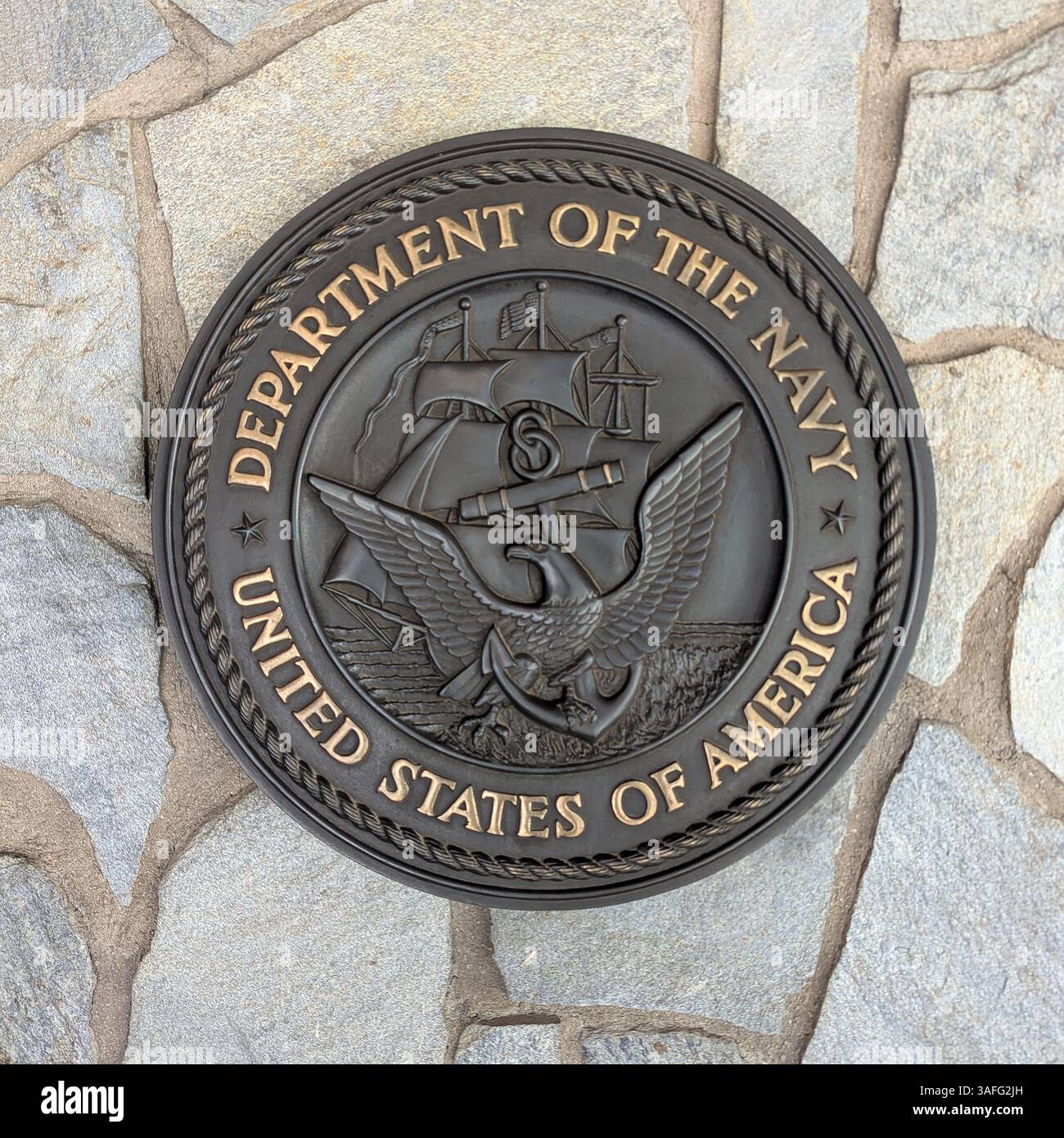 Bronze plaque of US Navy emblem or crest on natural stone wall Stock ...
