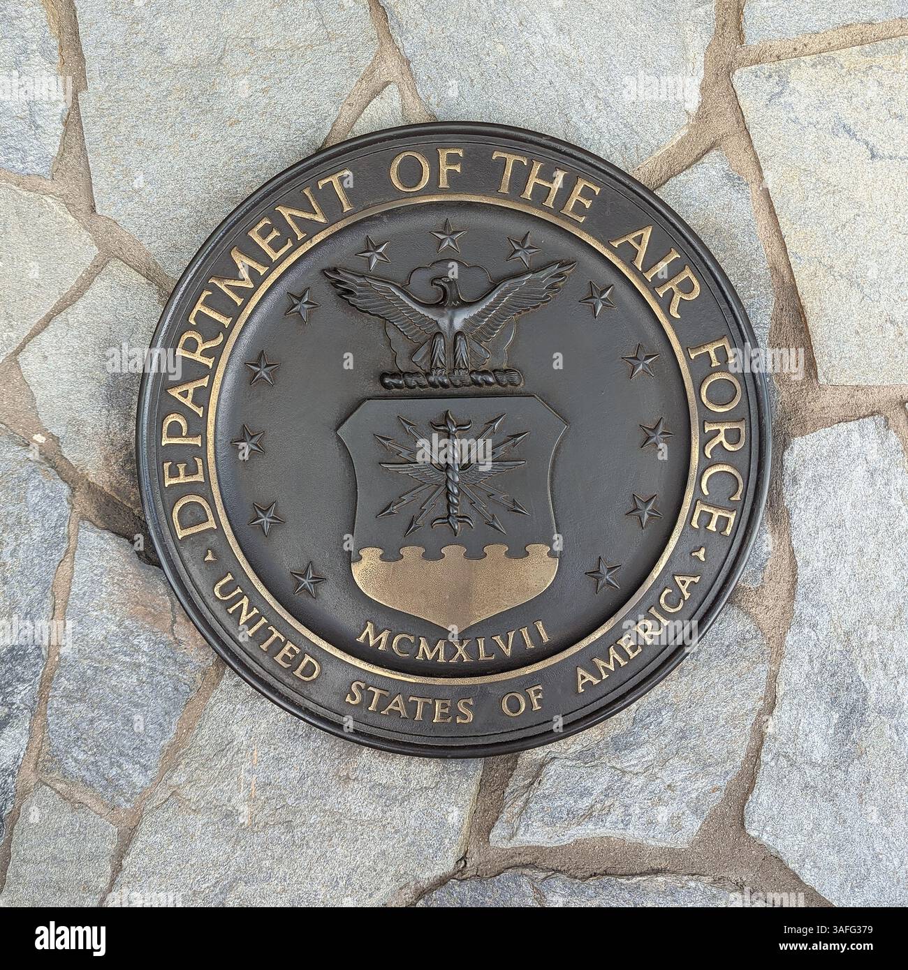 Bronze plaque of US Air Force emblem or crest on natural stone wall ...