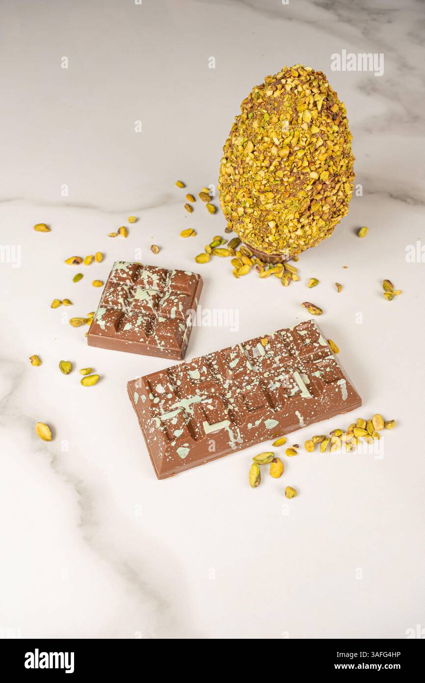 Milk chocolate bar and Easter egg with pistachio pieces vertical Stock ...