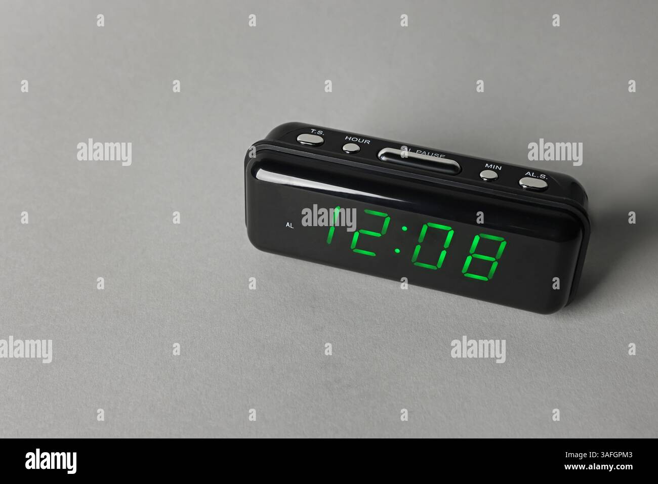 Digital alarm clock showing 12:08 o'clock on grey background, space for ...