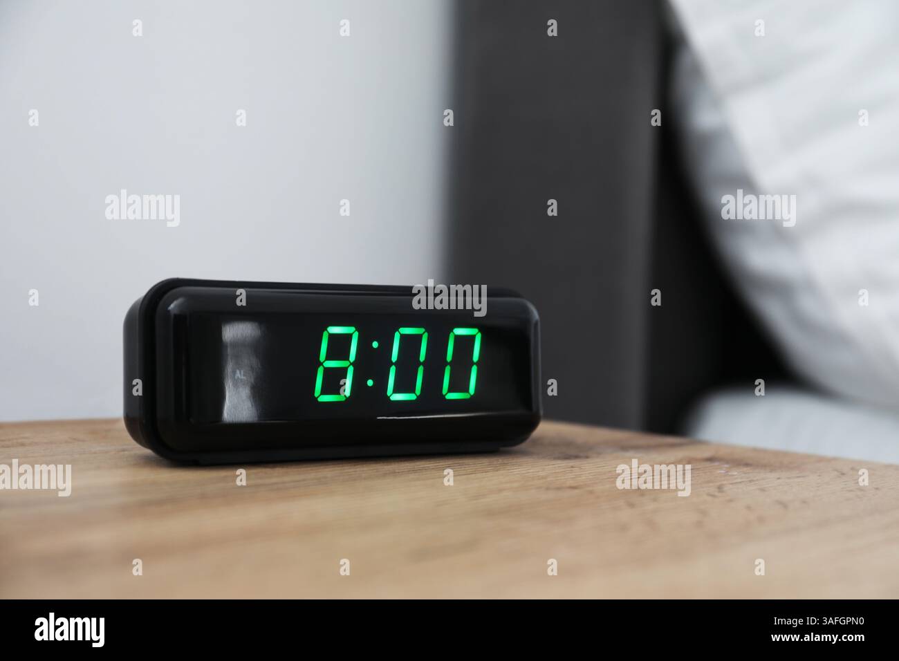Digital alarm clock showing 8:00 o'clock on bedside table indoors Stock ...