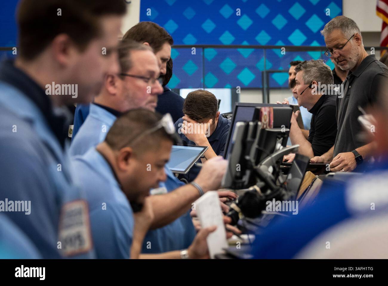 A trader holds his head in his hand as he works in the S&P options pit ...