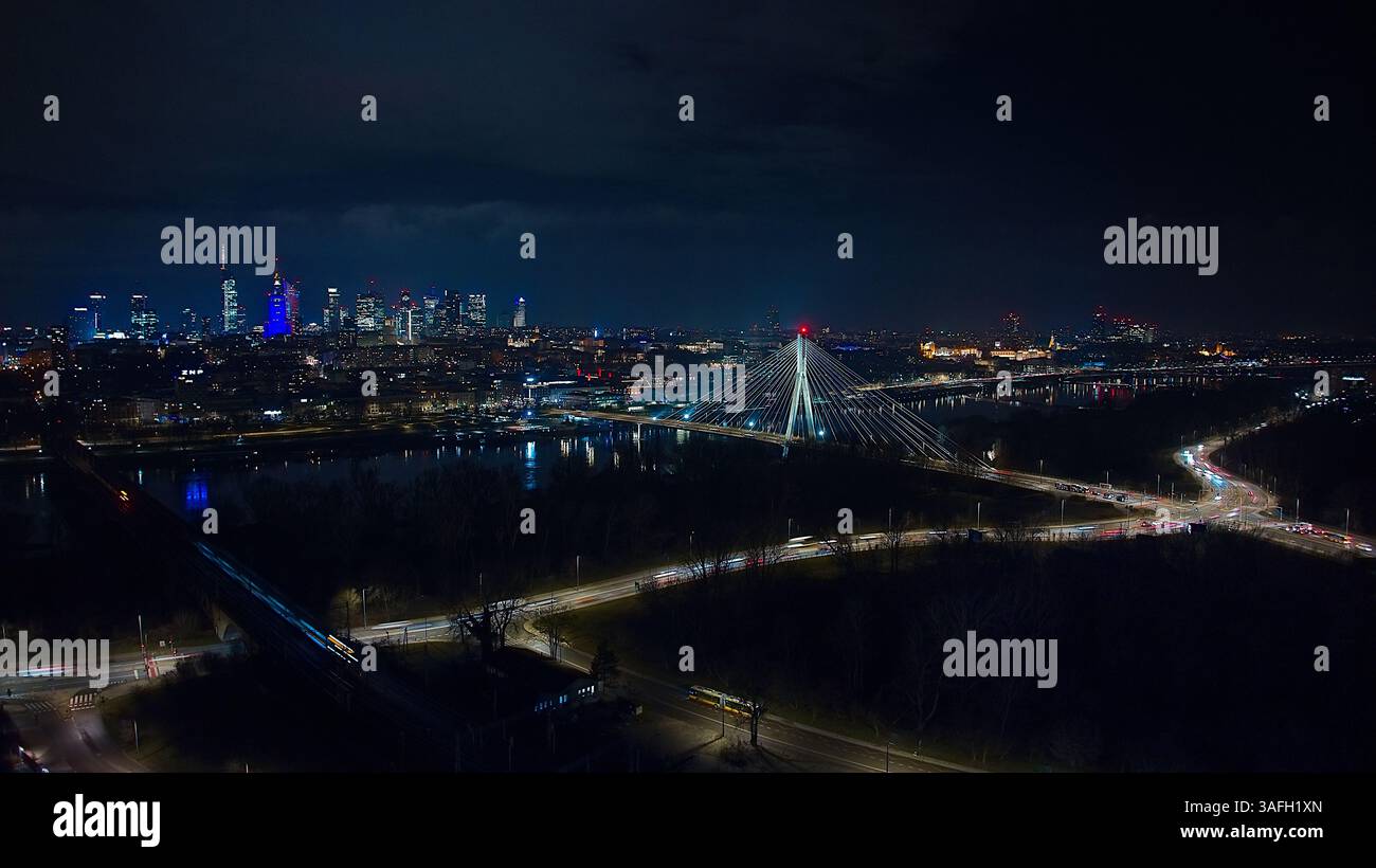 A night view of Warsaw from above—illuminated streets, towering ...
