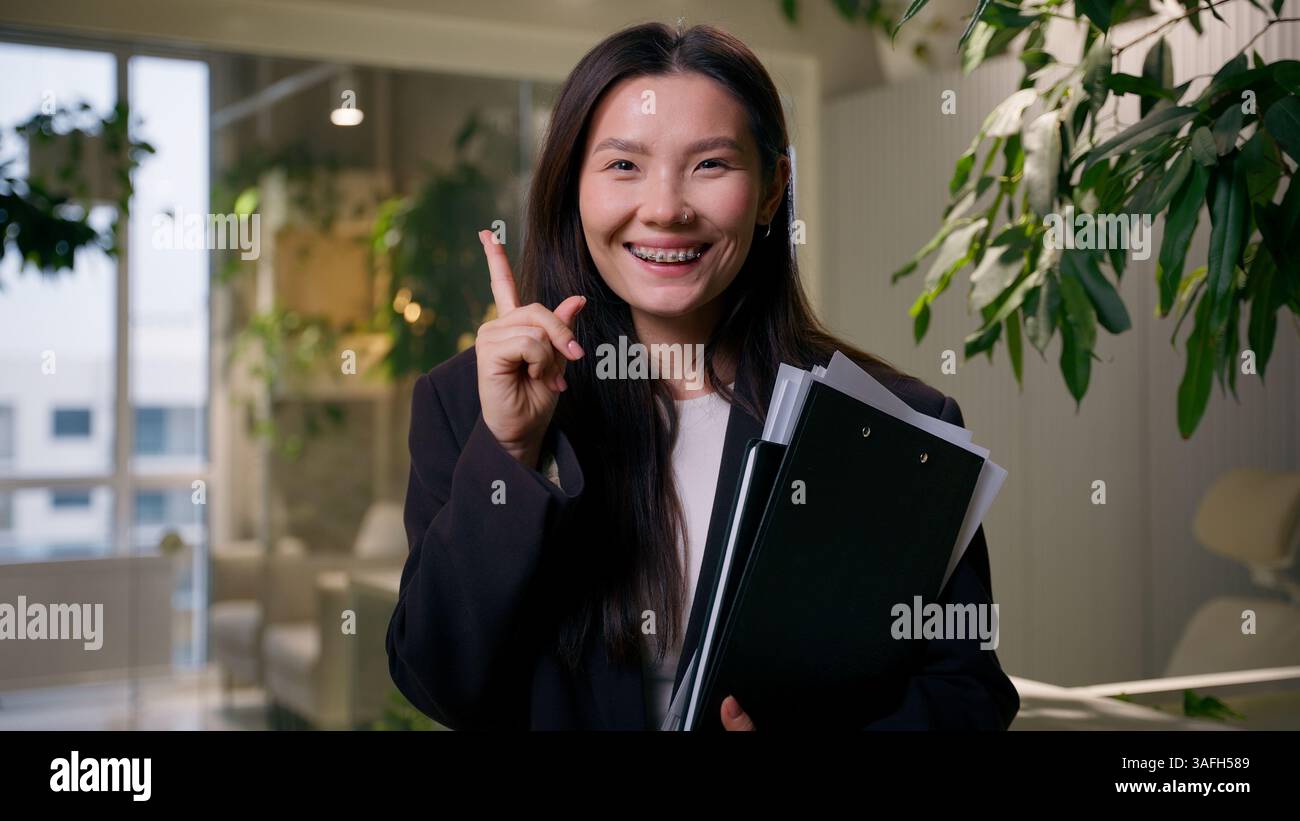 Thoughtful Asian business woman Korean employer thinking pensive office ...