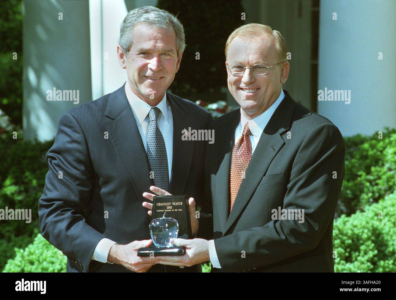 President George W. Bush presents a crystal apple to the 2002 National ...