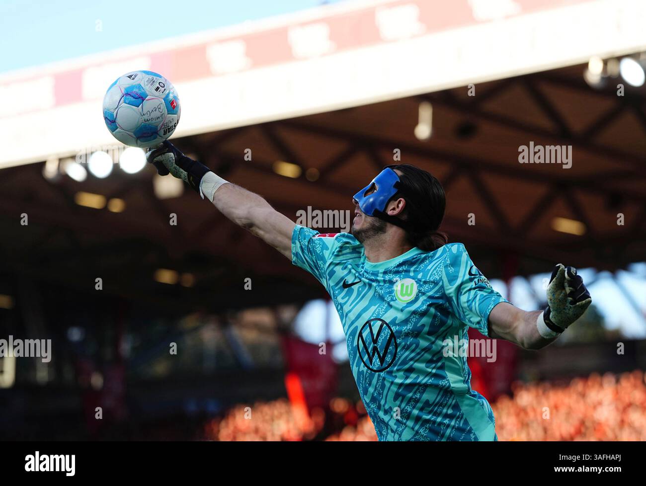 April 06 2025: Kamil Grabara of VfL Wolfsburg controls the ball during ...