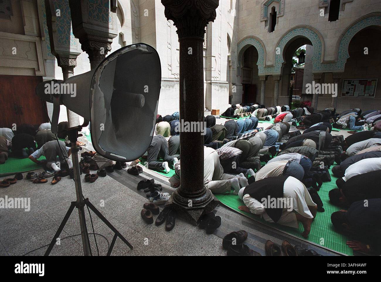 Facing in the direction of Mecca, Muslims pray in the afternoon at the ...