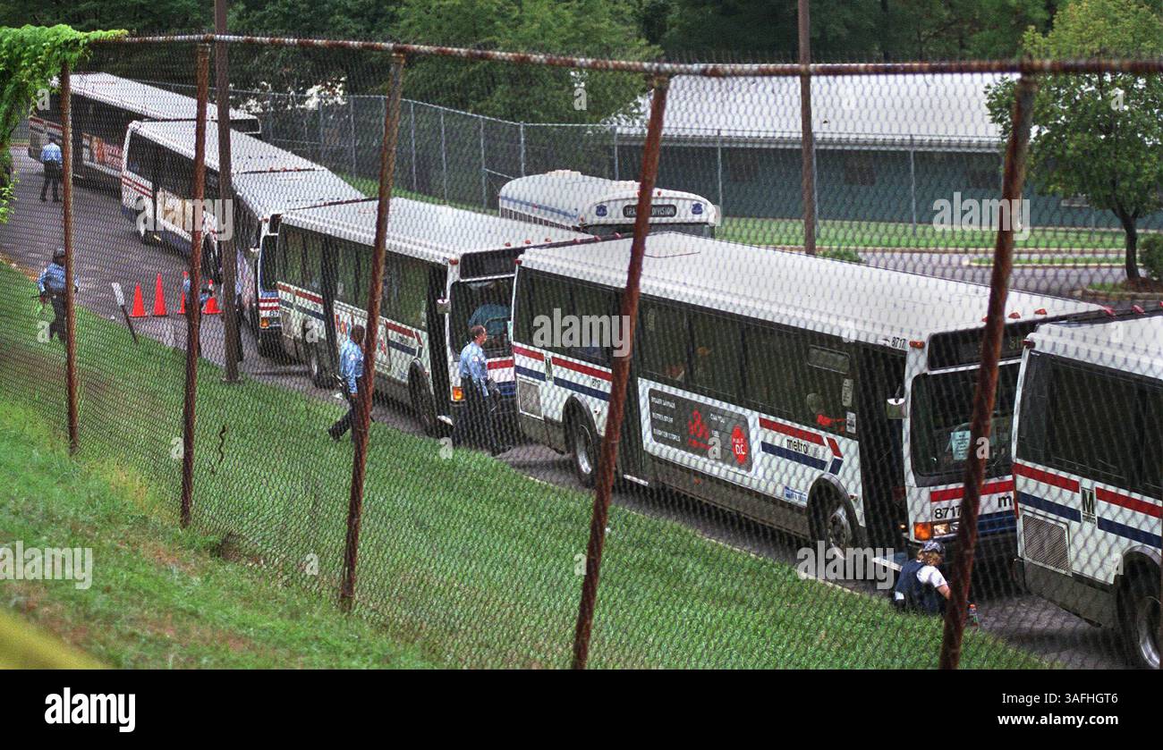 Buses full of protesters who were arrested downtown line up outside the ...