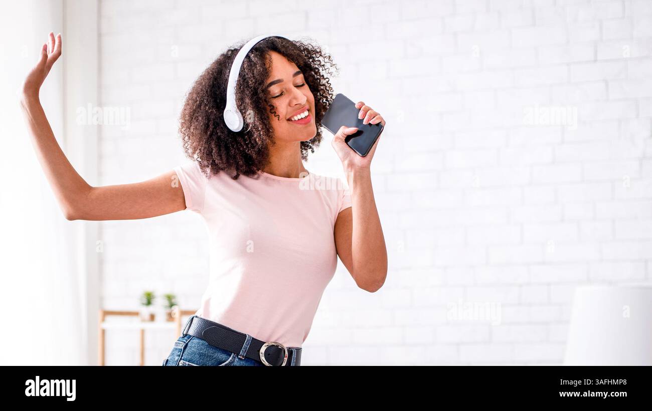 Musical mobile app and imaginary microphone. Funny african american ...