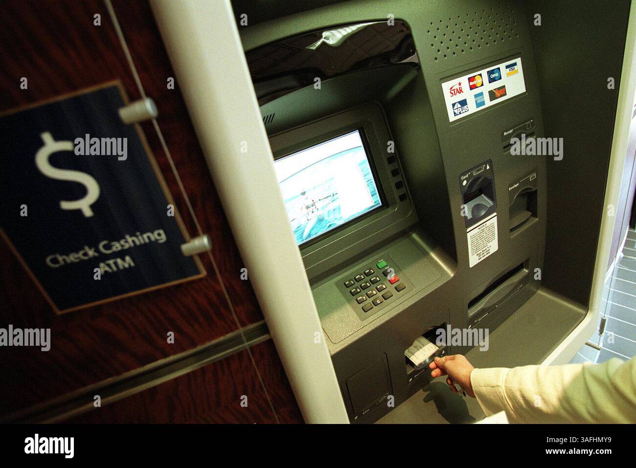 A check is cashed at a new check cashing ATM at Riggs Bank in ...