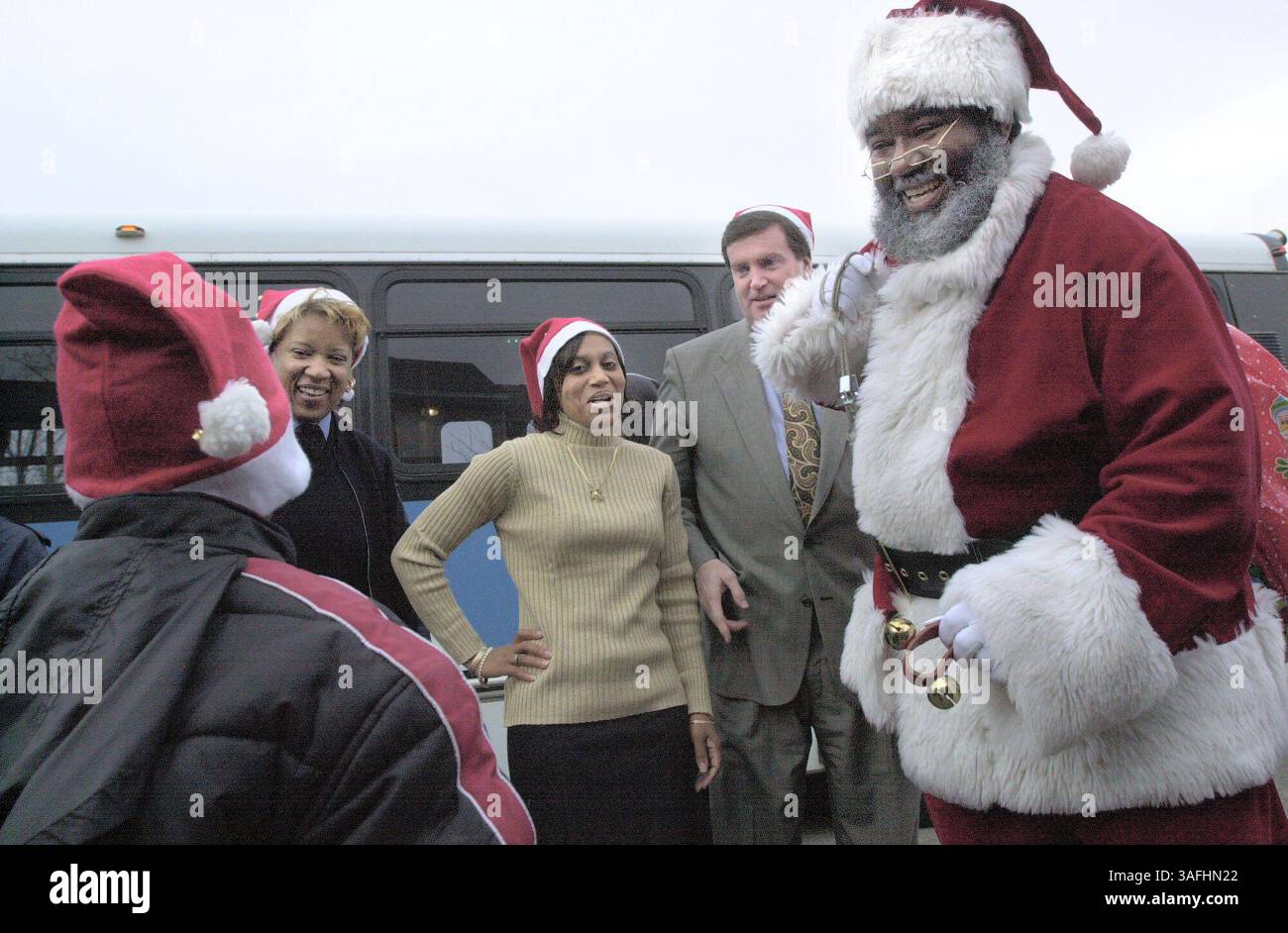 Santa Claus (aka Braxton Wiggins) greets DeVohn Johnson, 6, son of ...