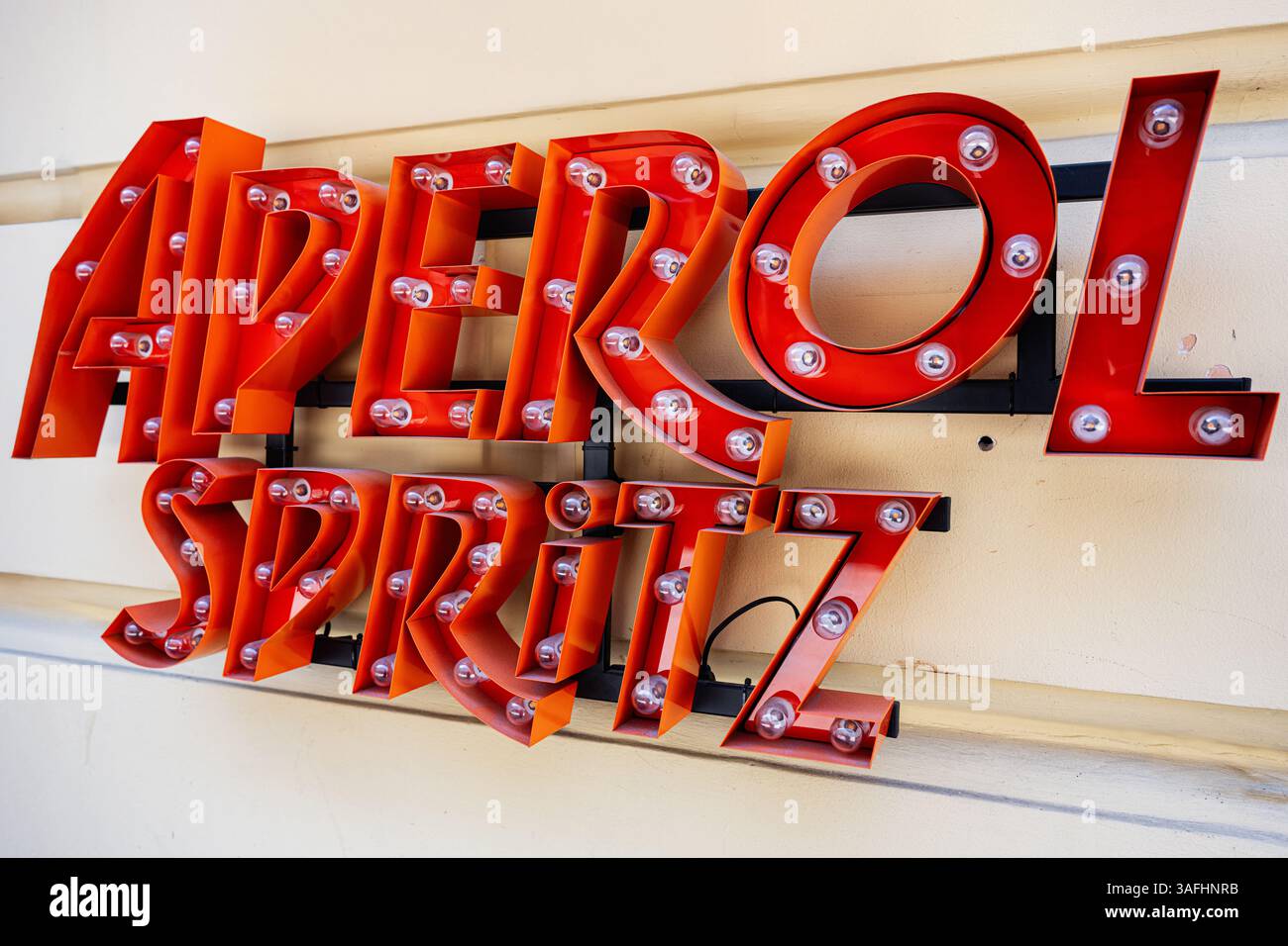 Lviv, Ukraine - April 06, 2025: Brightly lit Aperol Spritz sign with ...