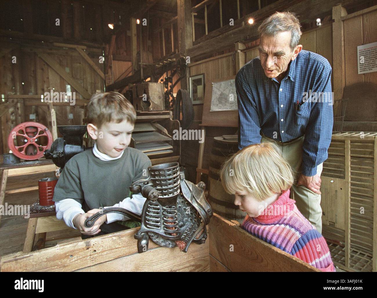 Volunteer George Burgess, 78, watches as John Paul Wehner, 5, turns the ...