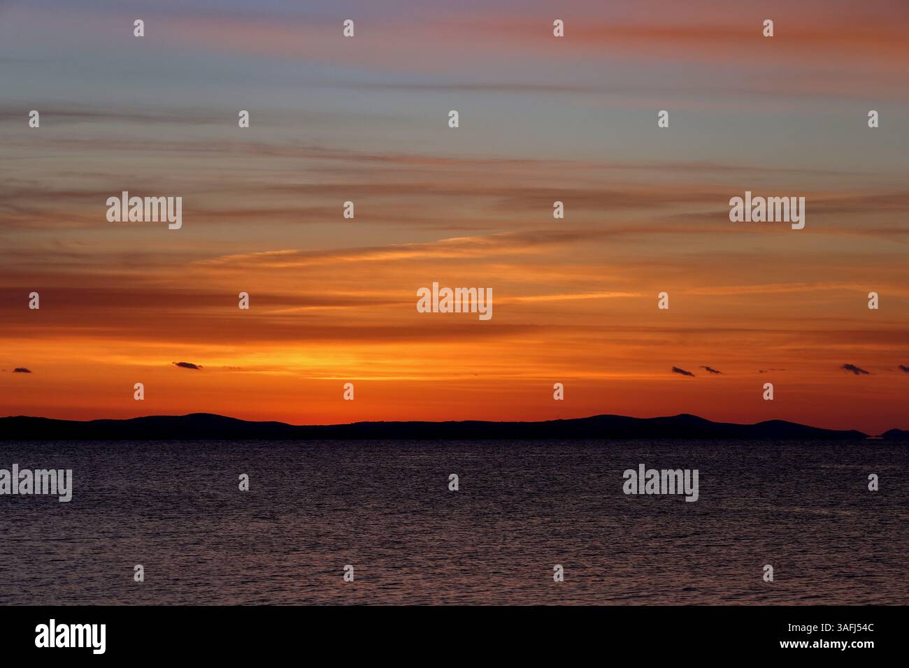 People enjoy the beautiful sunset at the Greeting to the Sun. Monument ...
