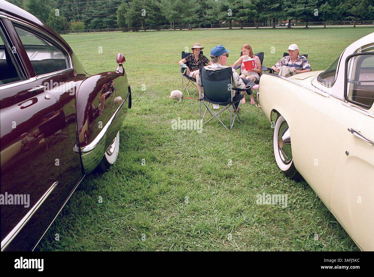 Randy Denchfield, in cap at right, sits with his family between two of ...