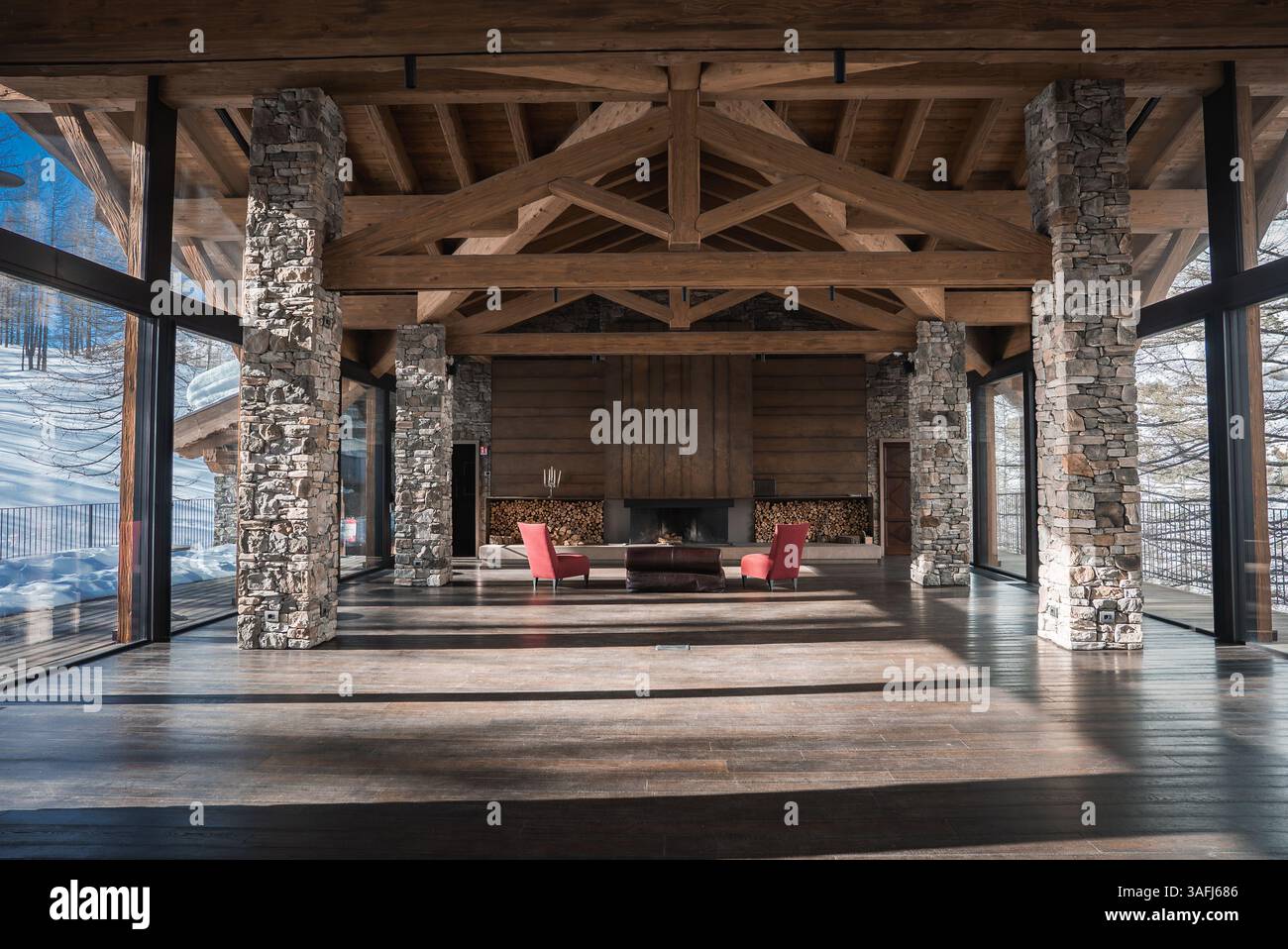 Interior of Luxury Alpine Hotel Lounge with Fireplace and Snowy Views ...