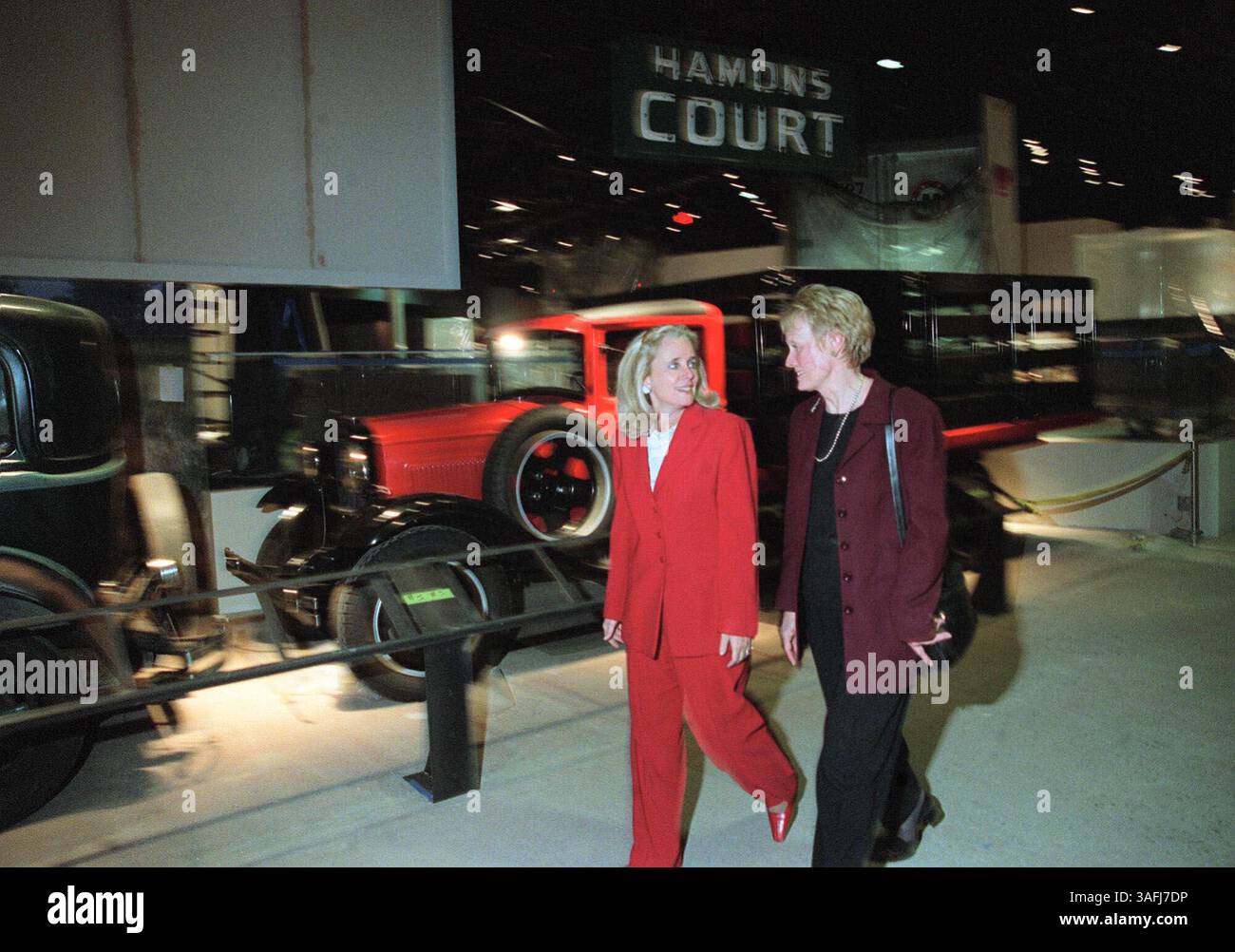 Debie Dingell and Marcelle Leahy stroll past a 1931 Ford Model AA truck ...