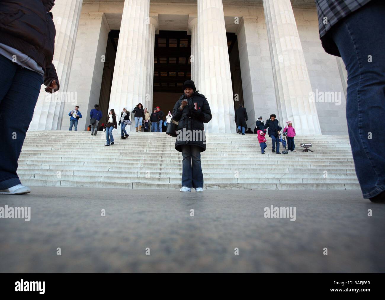 A girl takes a picture on her cell phone of the spot where Martin ...
