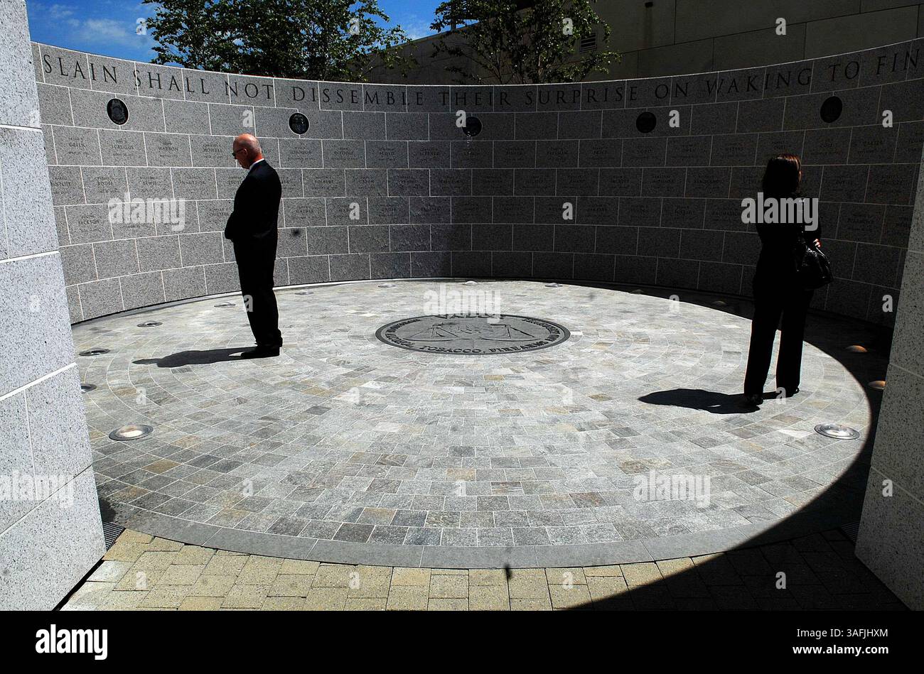 Invited guests take a look at the one of the memorials attached to the ...