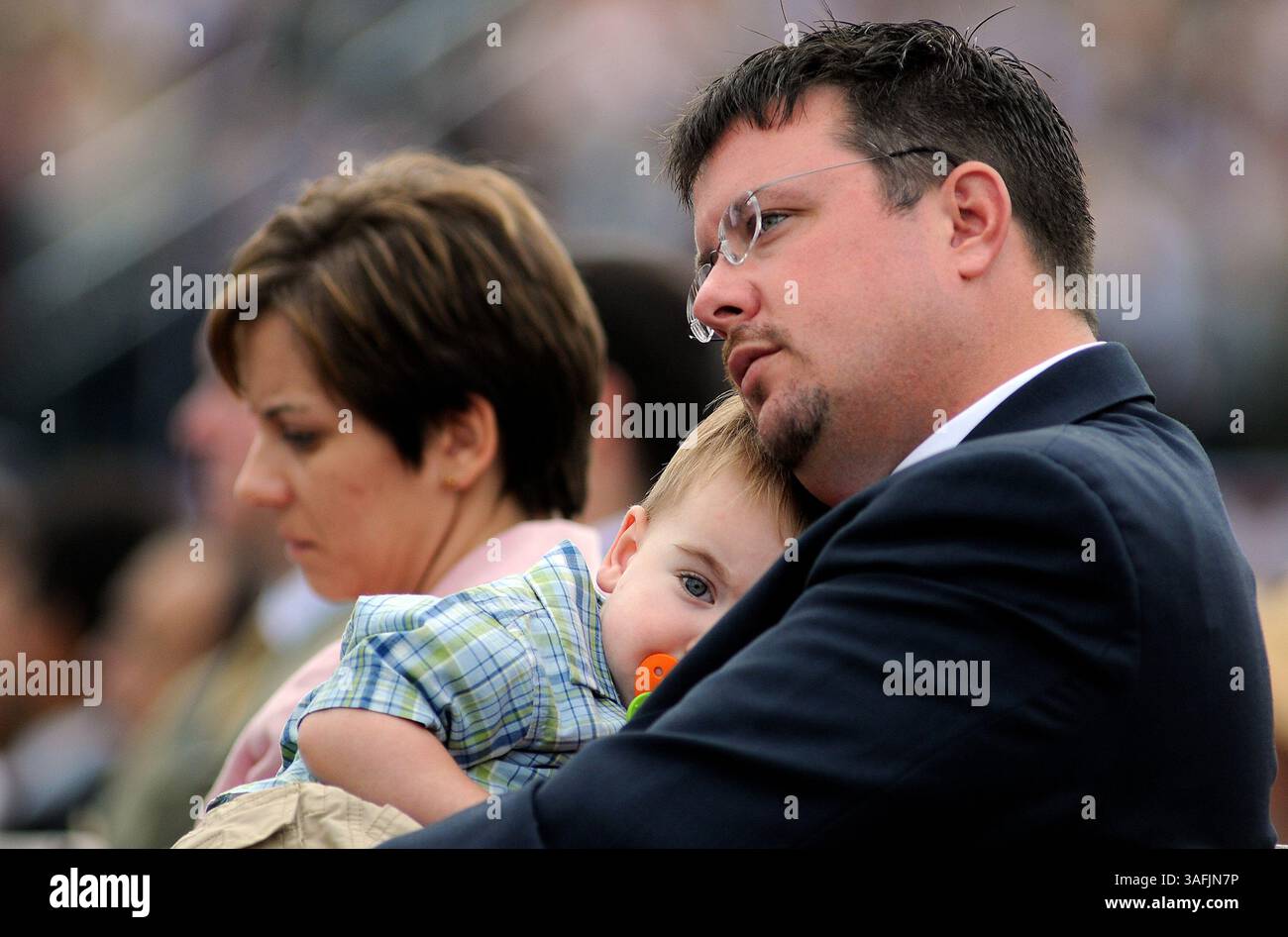 Chris Hartzler, from Ashburn, Virginia, holds his son Ryan, 2, in his ...