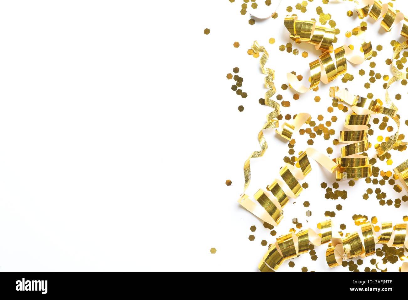 Shiny golden serpentine streamers and confetti on white background, top ...