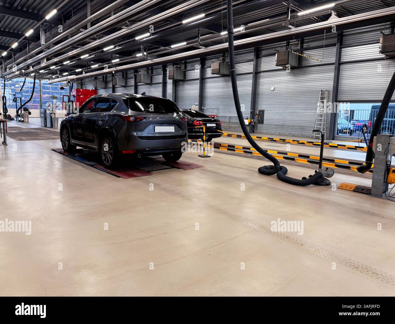 Modern cars undergoing procedure of vehicle inspection at station Stock ...