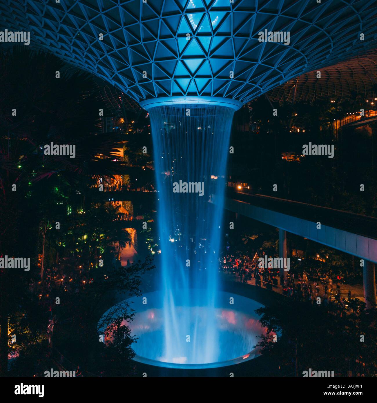 Stunning night view of Jewel Changi Airport's illuminated indoor ...